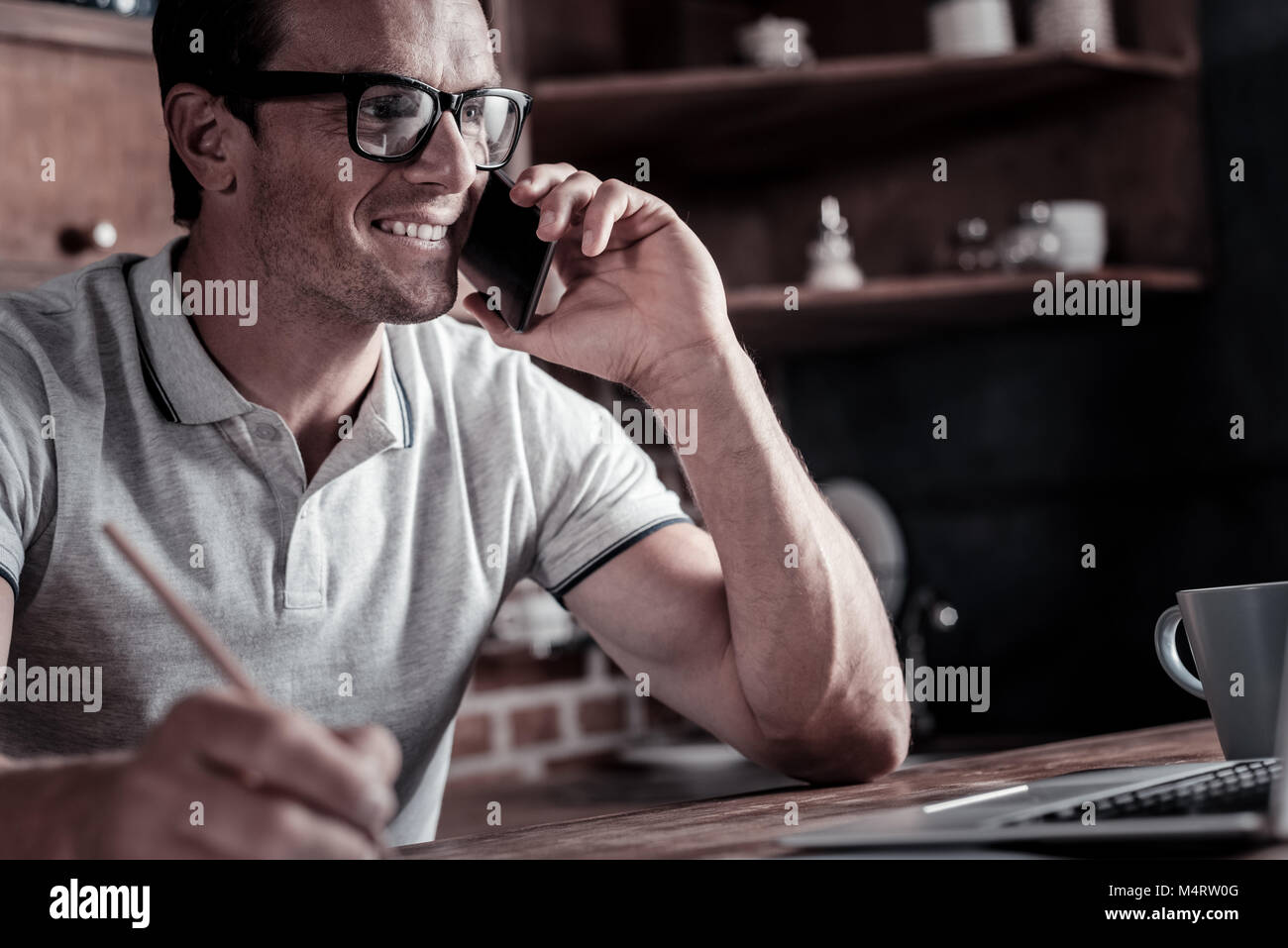 Adult businessman talking with client on phone Stock Photo - Alamy