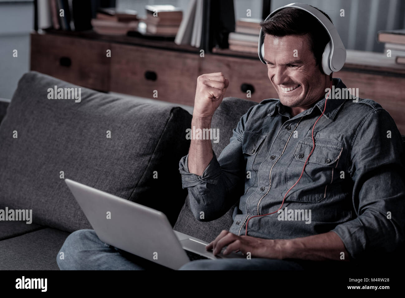 Millennial excited man celebrating success hi-res stock photography and ...