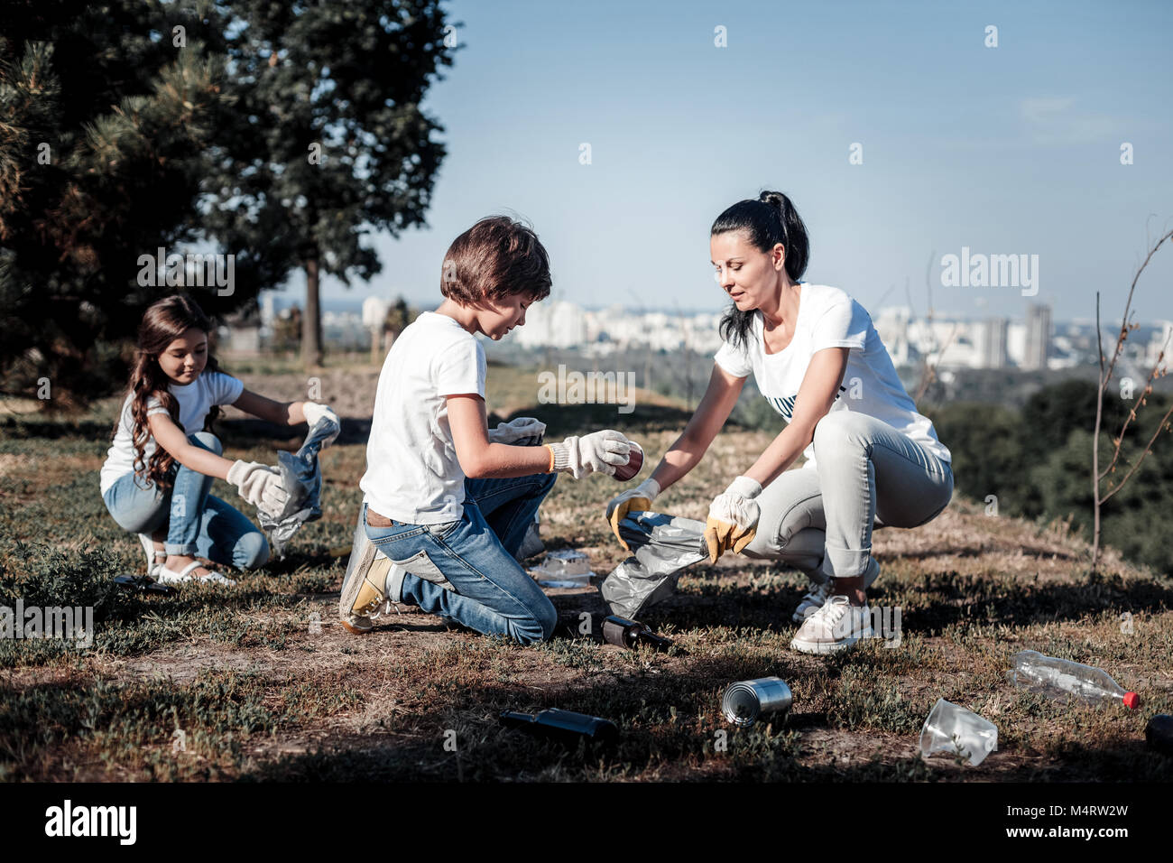 Nice pleasant children collecting garbage Stock Photo - Alamy