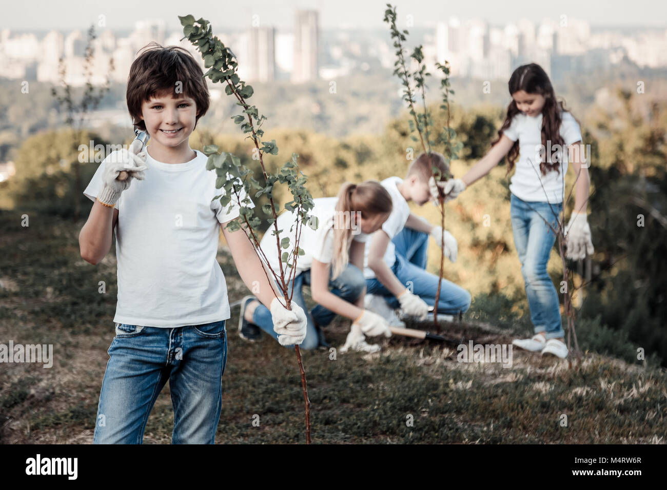Happy cute boy saving the environment Stock Photo - Alamy