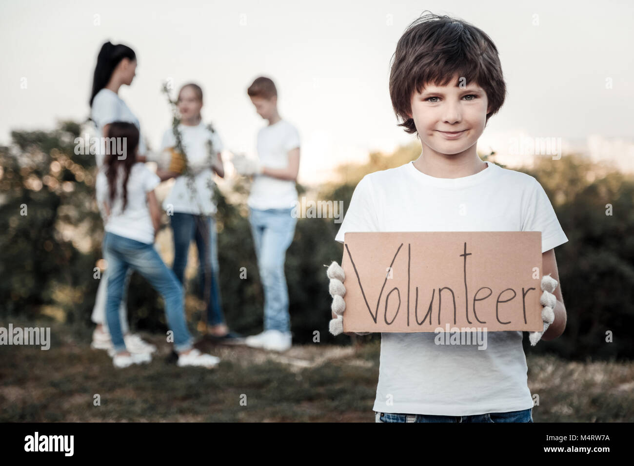 Cheerful nice boy being a volunteer Stock Photo - Alamy