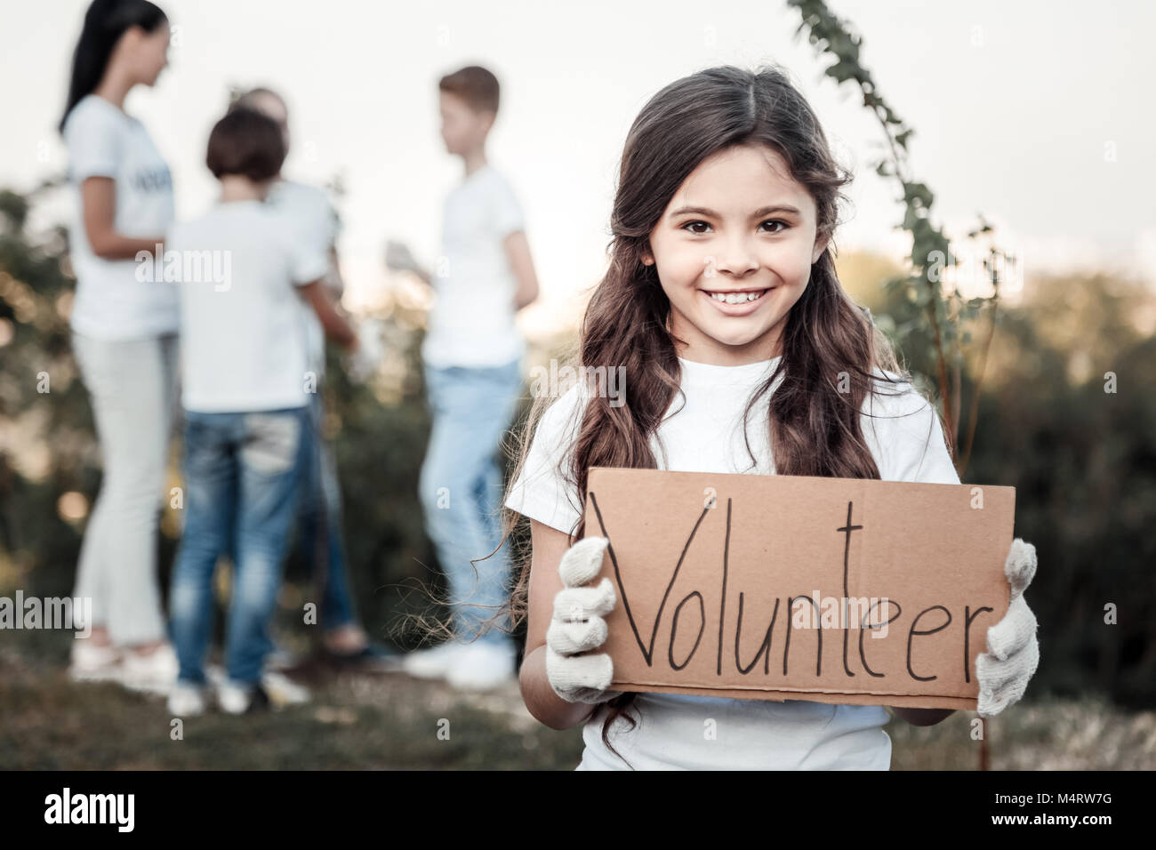 Happy cute girl being a volunteer Stock Photo - Alamy
