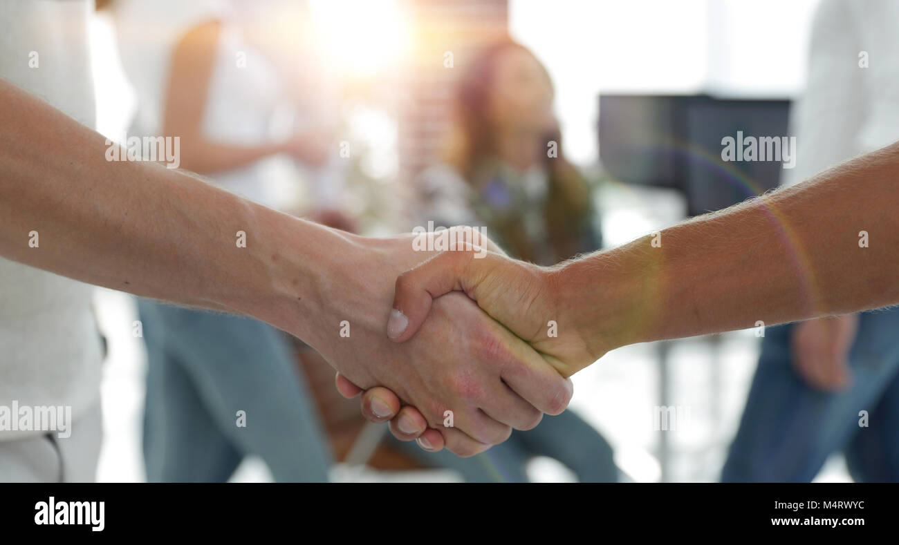 handshake colleagues in creative office Stock Photo - Alamy