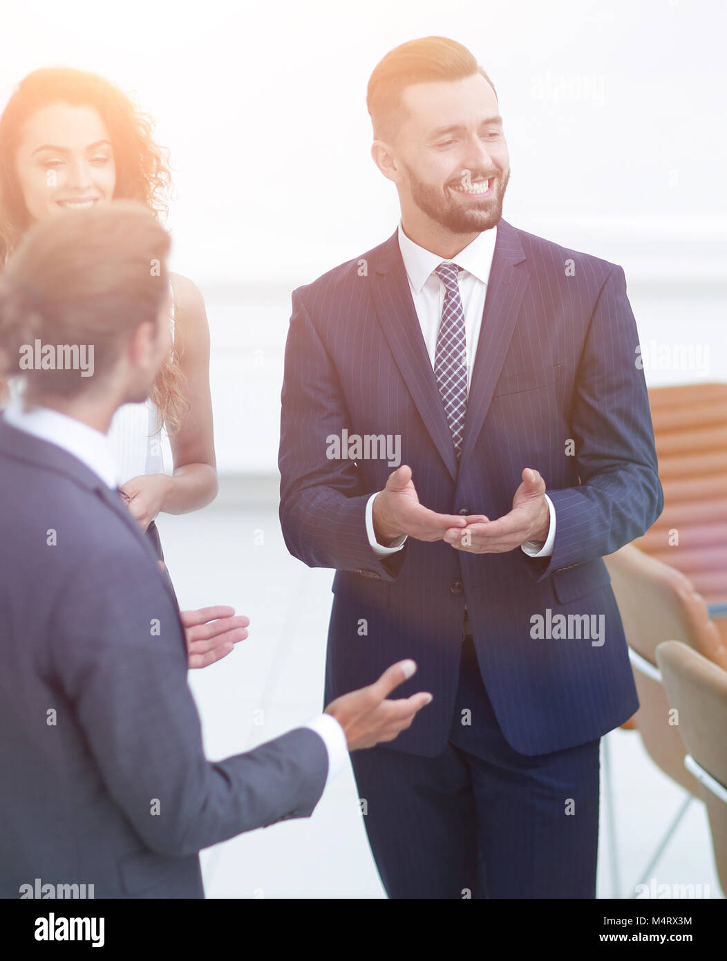 business team talking, standing in office Stock Photo - Alamy