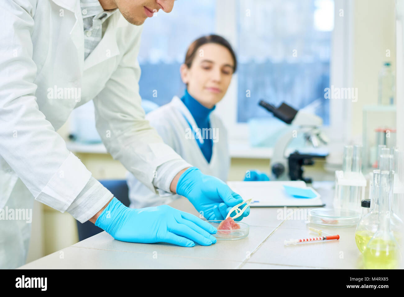 Group of talented young scientists wearing white coats gathered ...