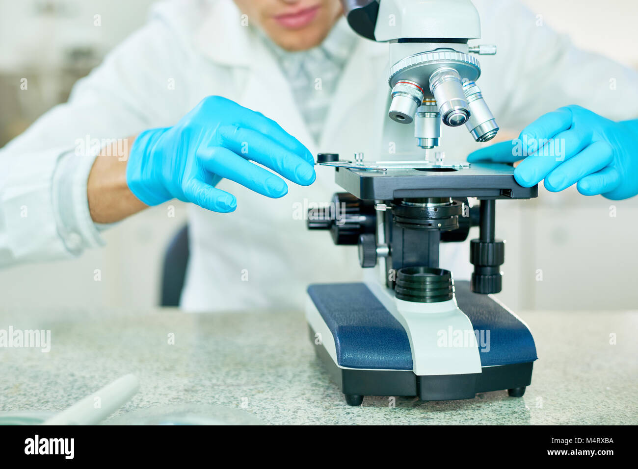 Close-up shot of unrecognizable male researcher wearing white coat and ...