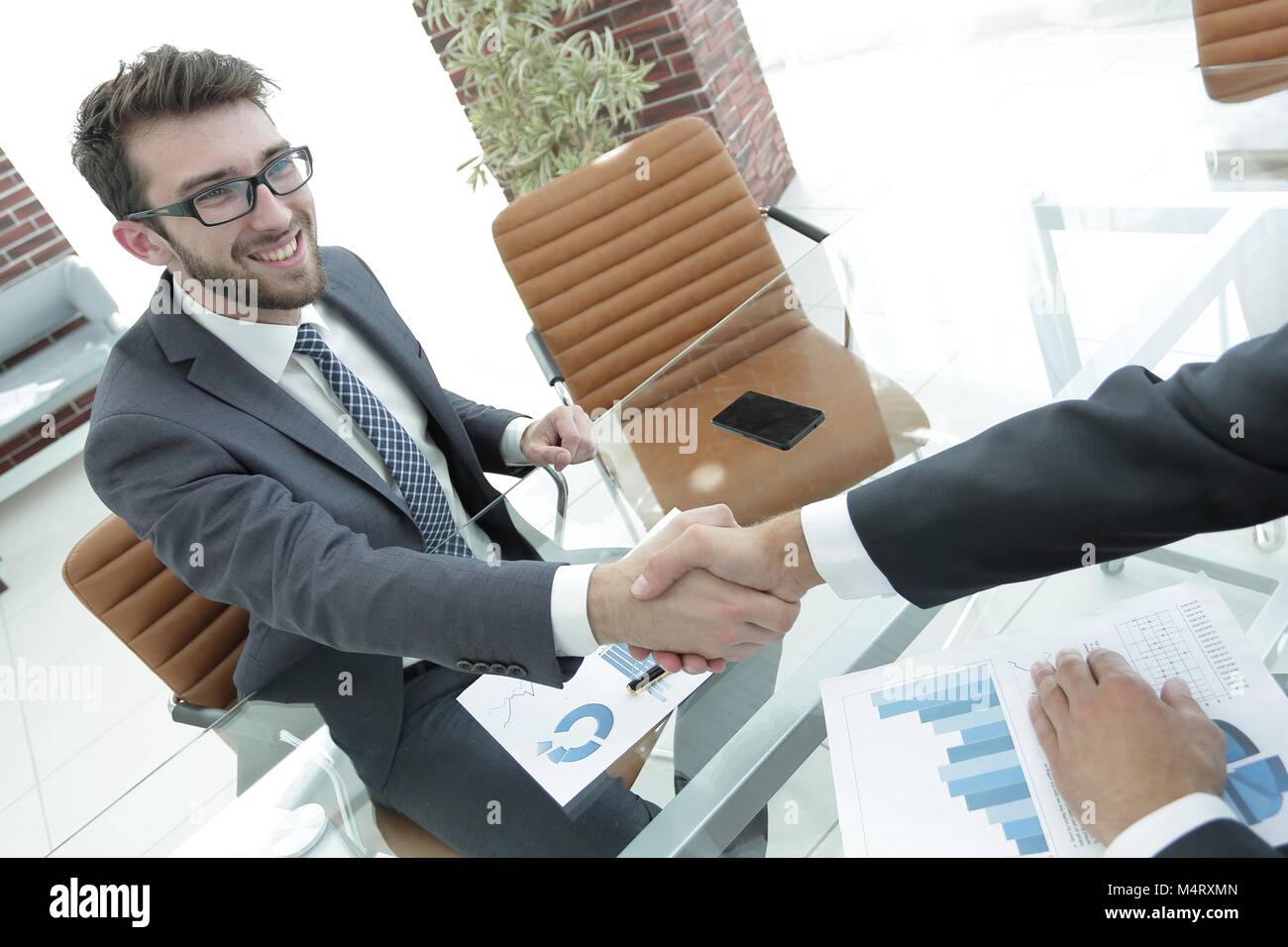 handshake business partners at your Desk Stock Photo - Alamy