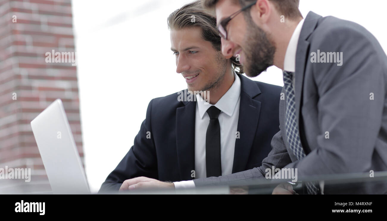 Male executives in office, looking at computer Stock Photo - Alamy