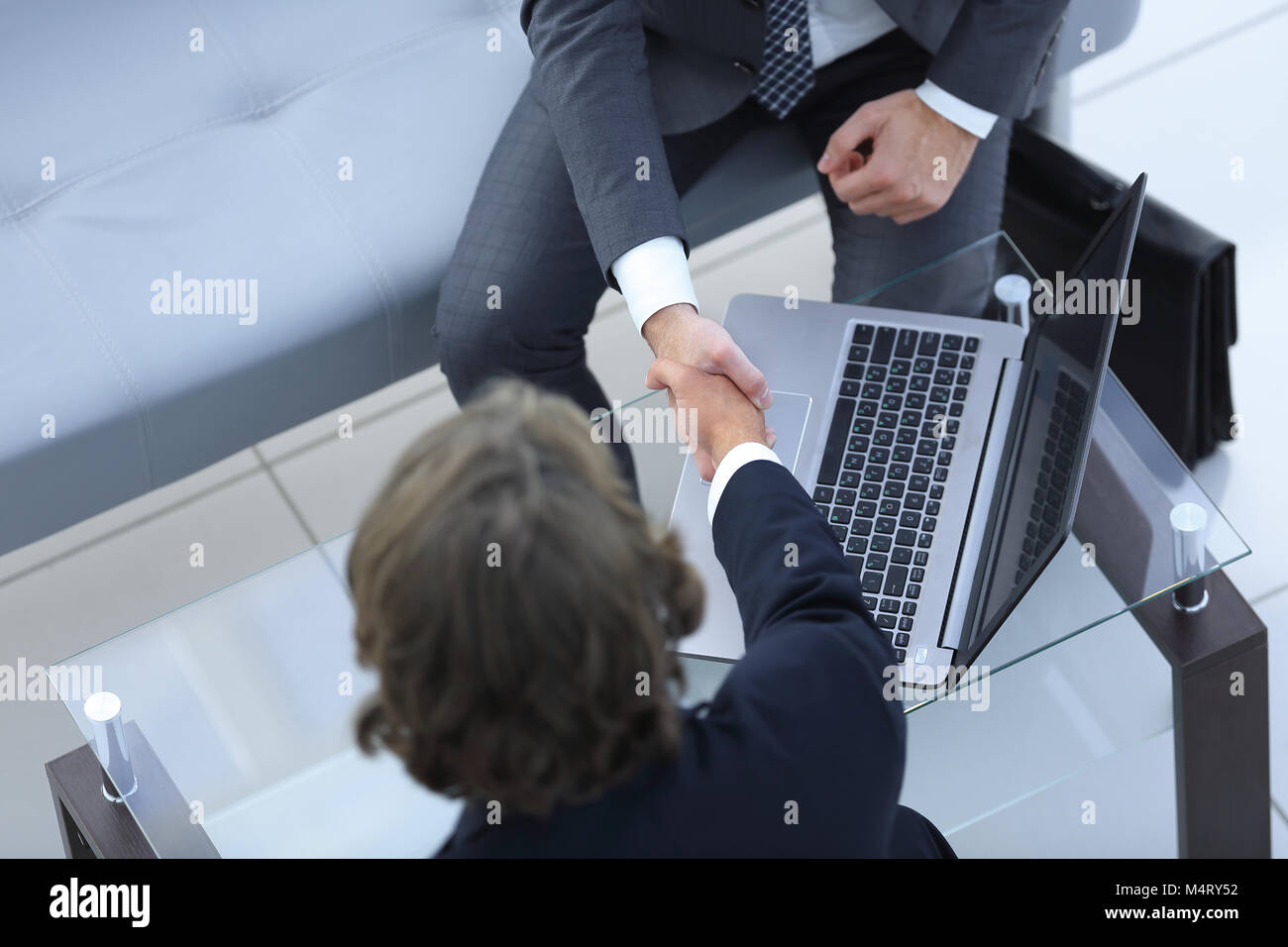 handshake of business partners above the Desk Stock Photo - Alamy