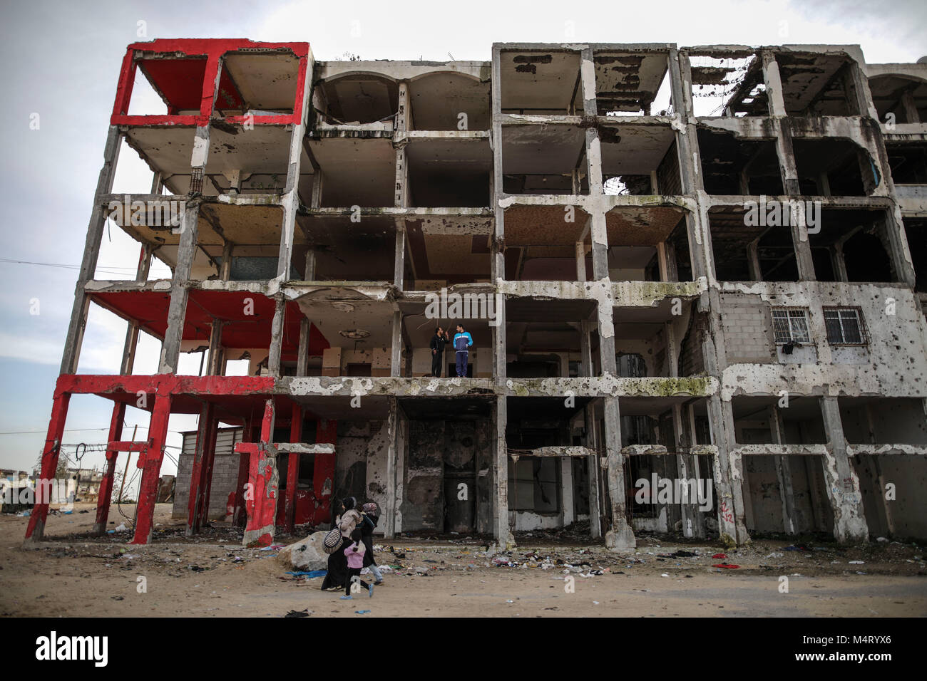 Palestinian family passes by the rubbles of Al-Nada residential ...