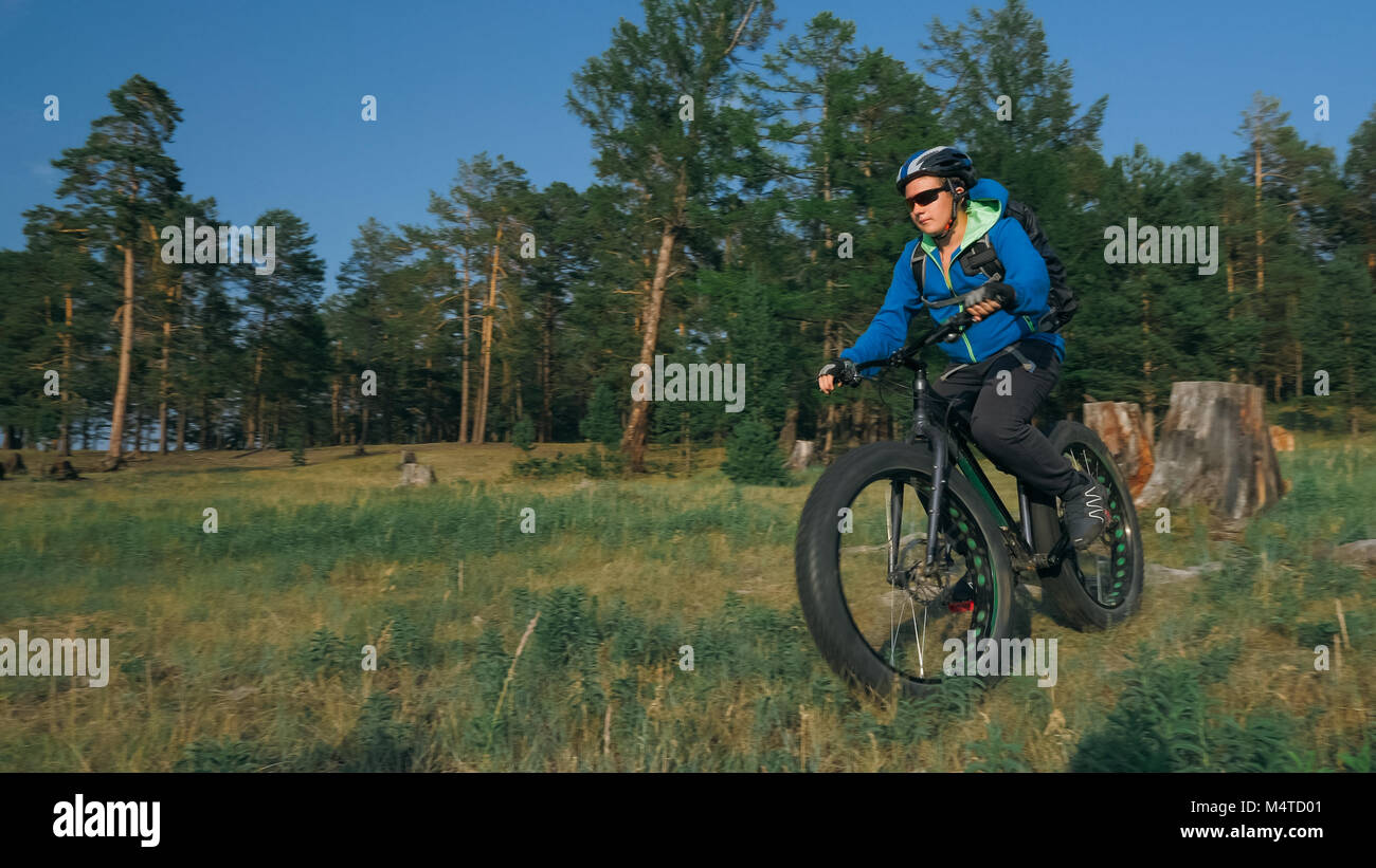 Fat bike also called fatbike or fat-tire bike in summer riding in the ...