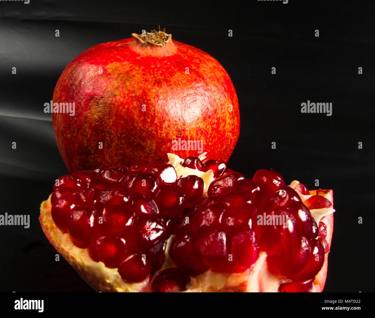 Big Pomegranate fruit fnd seeds on black background, closeup Stock ...