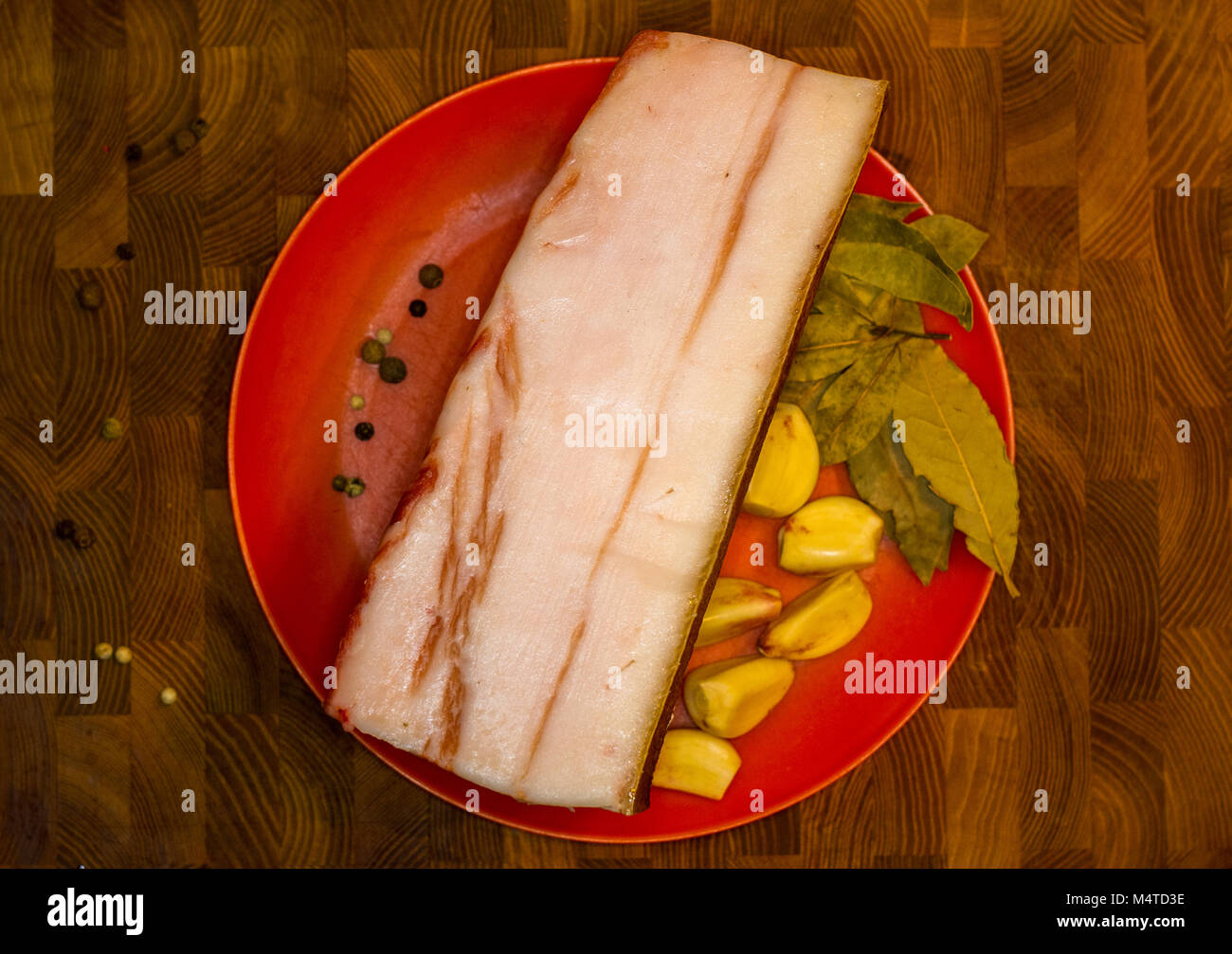 Cooking national Ukrainian dish - a big piece of raw of lard with ...