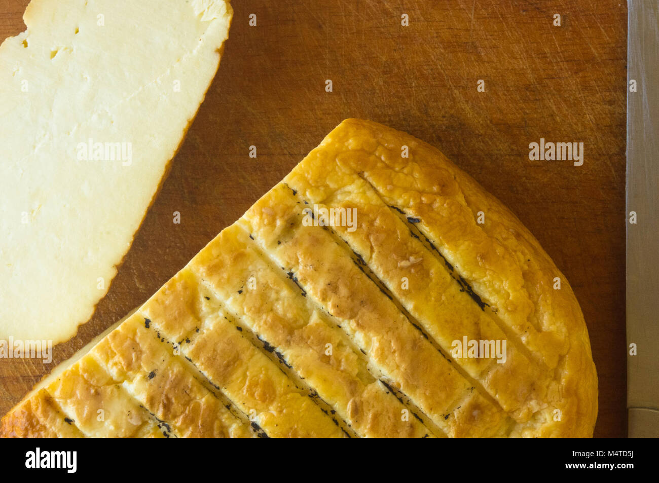 cut head of traditional Adygei cheese handmade on wooden Board Stock ...