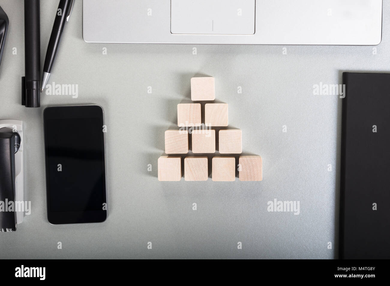 Pyramid Made With Wooden Block On Office Desk Stock Photo - Alamy