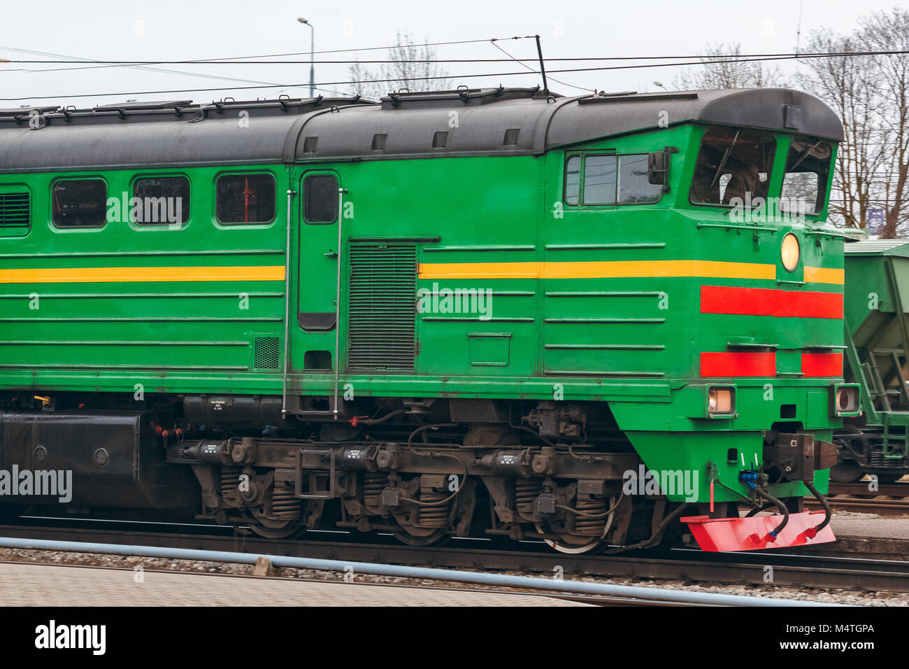 Green diesel cargo locomotive. Freight train in action Stock Photo - Alamy