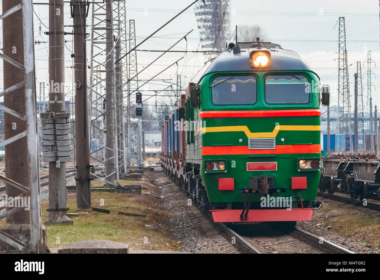 Green diesel cargo locomotive. Freight train in action Stock Photo - Alamy