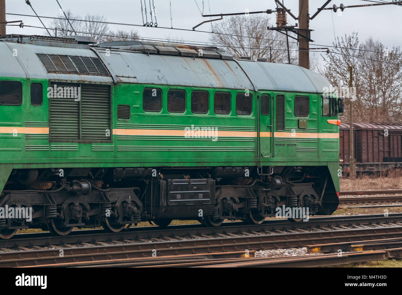 Green diesel cargo locomotive. Freight train in action Stock Photo - Alamy