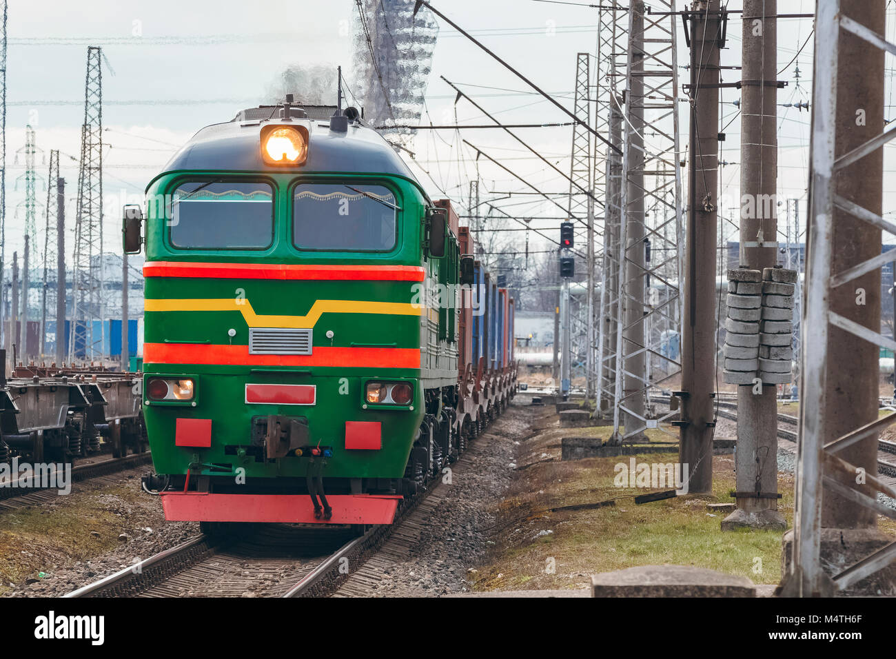 Green diesel cargo locomotive. Freight train in action Stock Photo - Alamy