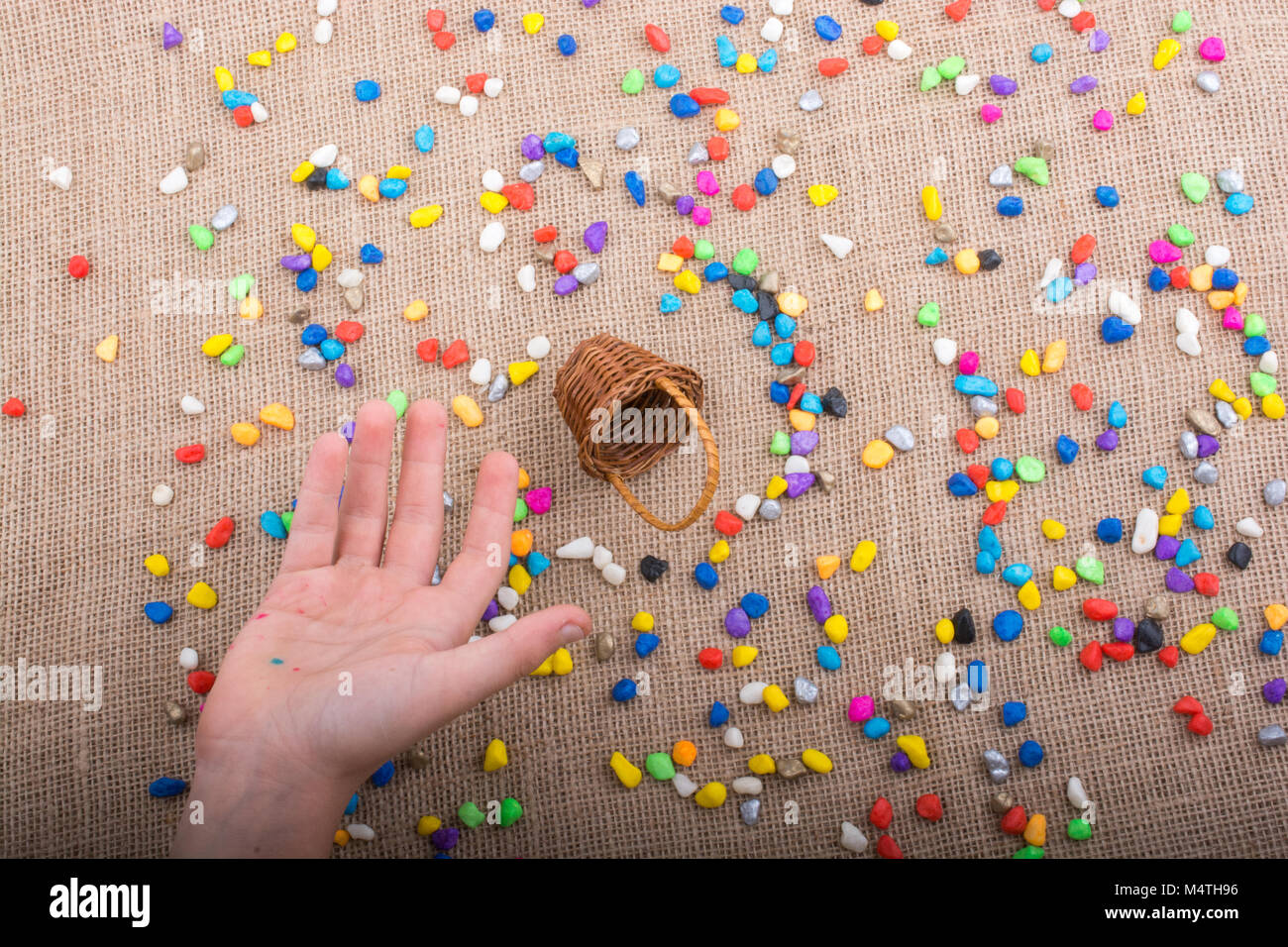 Bucket of colorful pebbles spill on background Stock Photo - Alamy