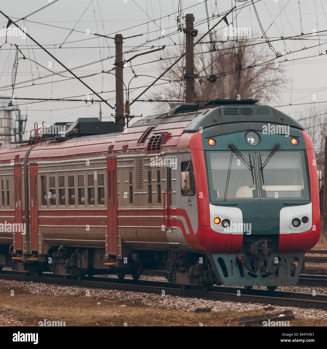 Red diesel passenger train driving at the old terminal Stock Photo - Alamy