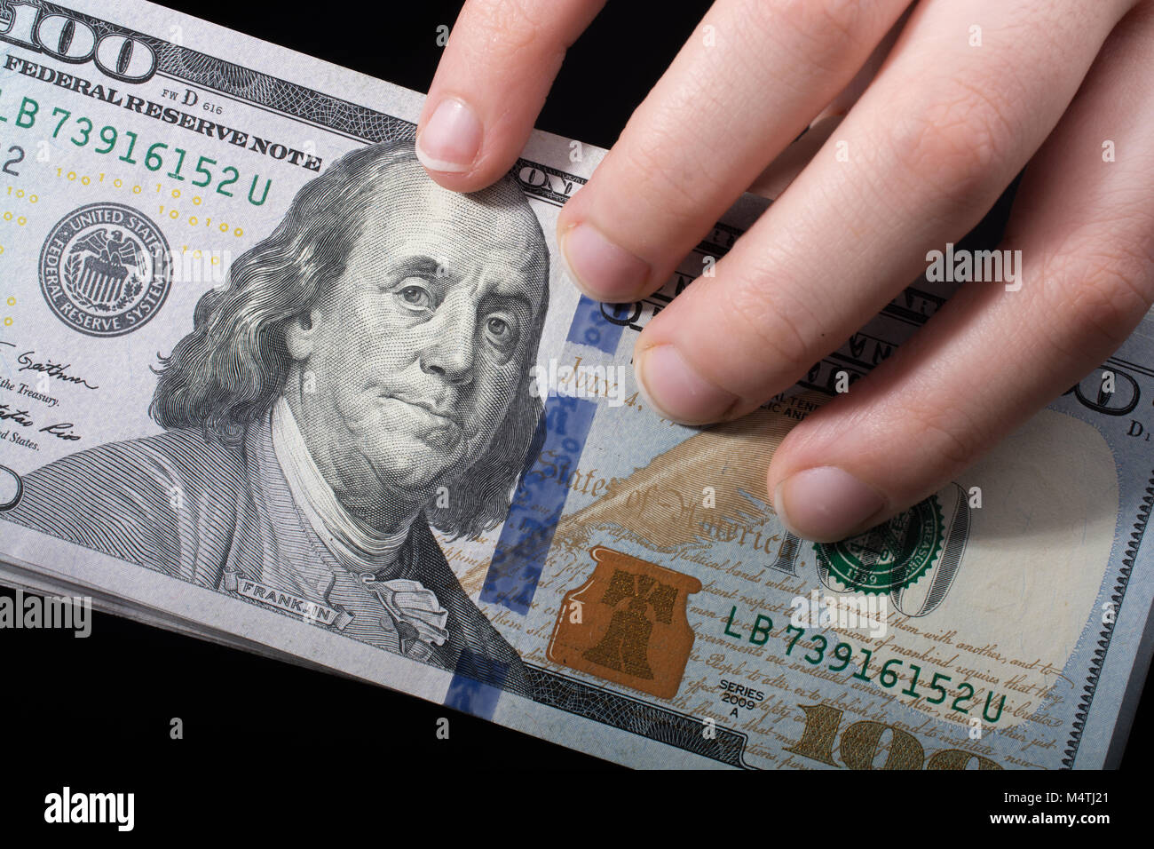 Hand holding American dollar banknotes isolated on white background ...