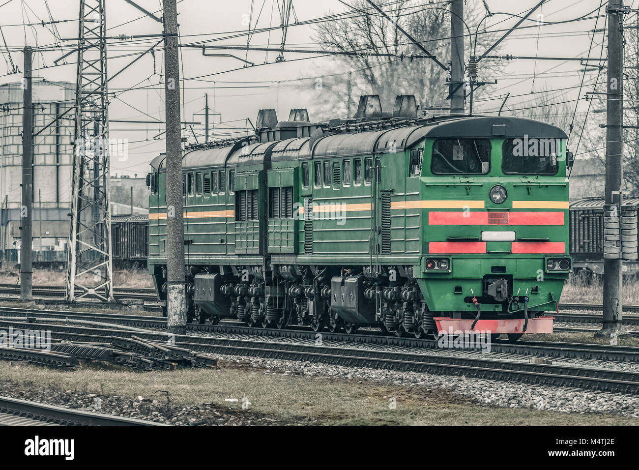 Green diesel cargo locomotive. Freight train in action Stock Photo - Alamy