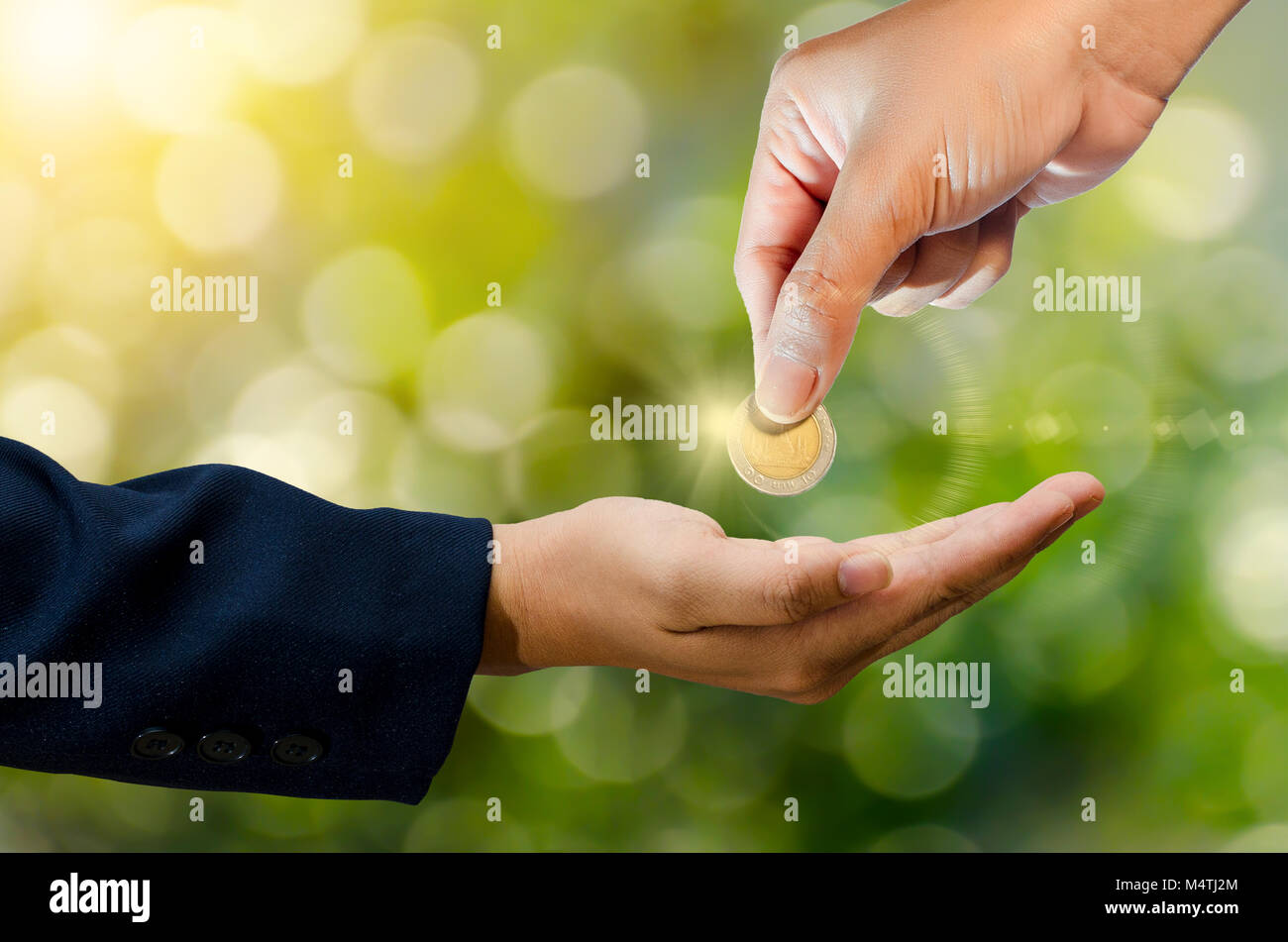 hand send coin green bokeh background Stock Photo - Alamy