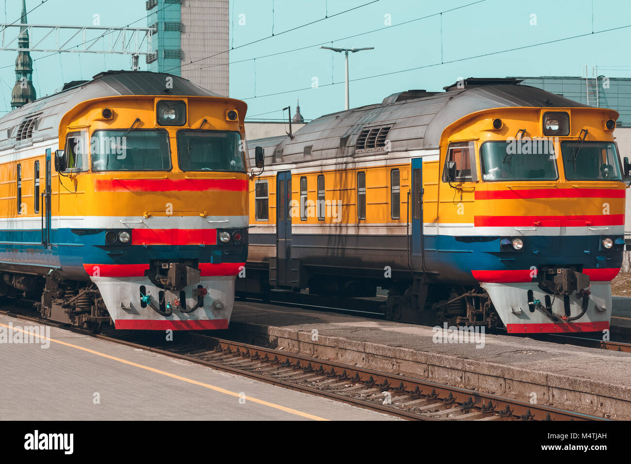 Old yellow passenger diesel train moving at the terminal Stock Photo ...