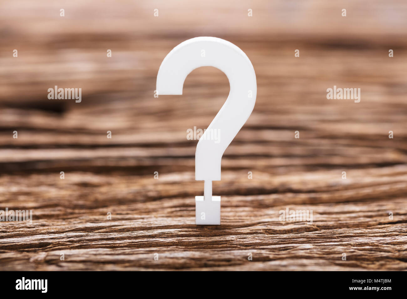Close-up Of A White Question Mark Sign On Wooden Table Stock Photo - Alamy