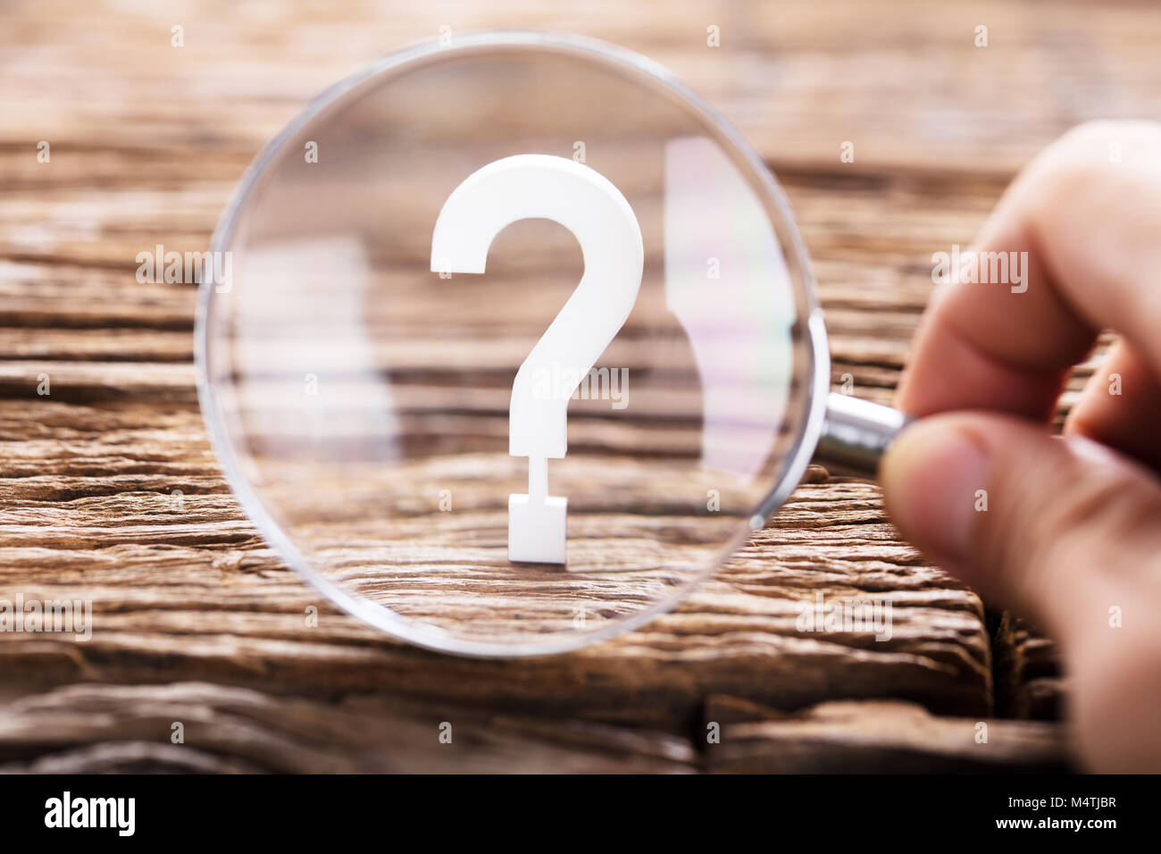 A Person Looking At Question Mark Sign Through Magnifying Glass Stock ...