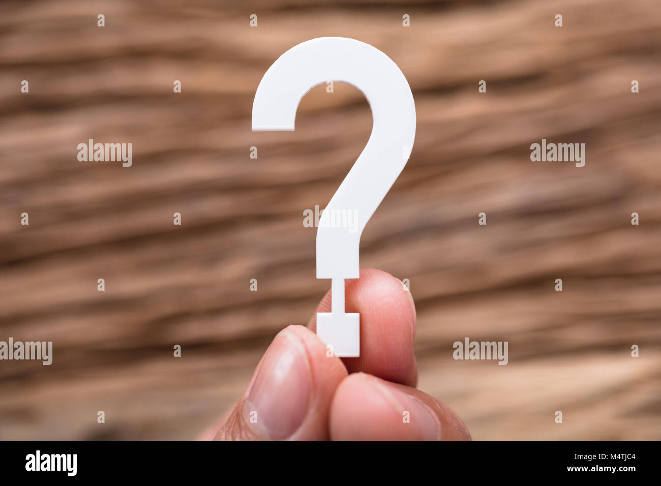 Close-up Of A Human Hand Holding White Question Mark Sign Stock Photo ...