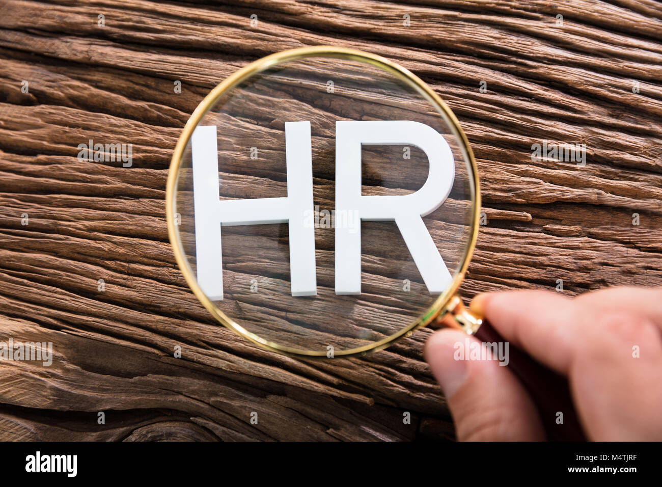 Elevated View Of A Person Looking At HR Text Through Magnifying Glass ...