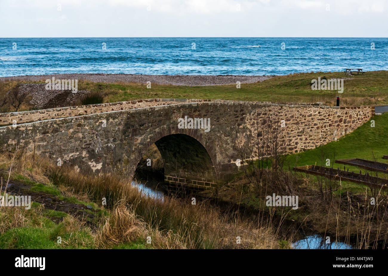 Old stone humpback bridge across small river, Nethermill, Aberdeenshire ...