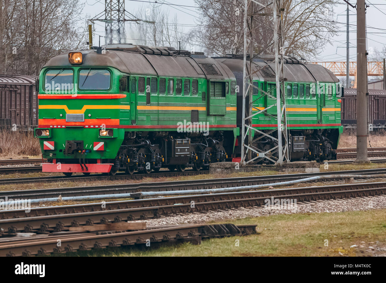 Green diesel cargo locomotive. Freight train in action Stock Photo - Alamy
