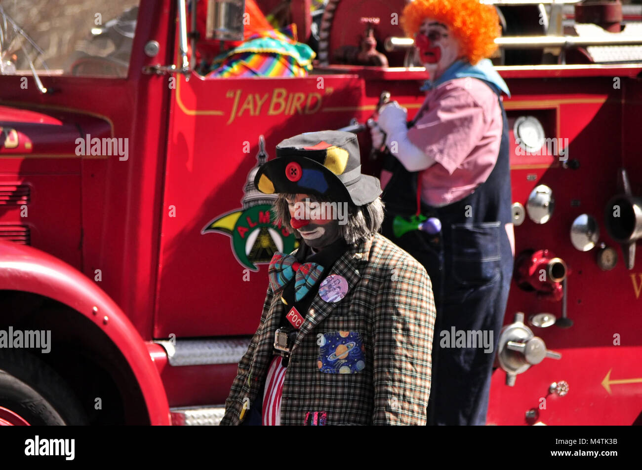 Clowns in Parade with fire engine Stock Photo - Alamy
