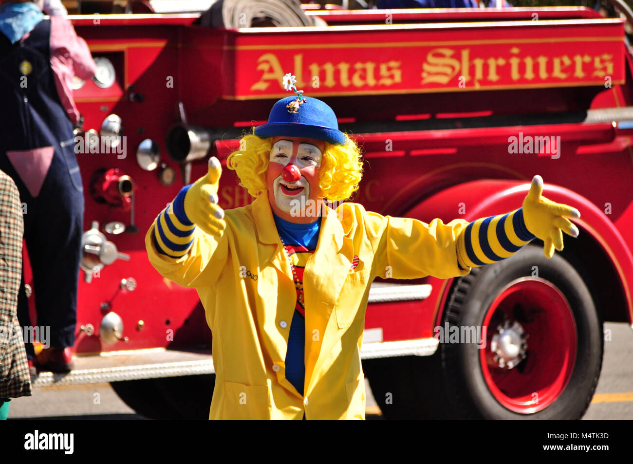 Clowns in Parade with fire engine Stock Photo - Alamy