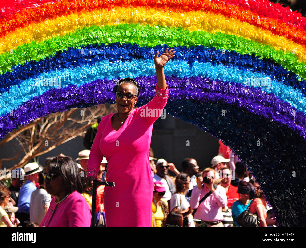 Regina Bell waving on float with rainbow background in Cherry Blossom ...