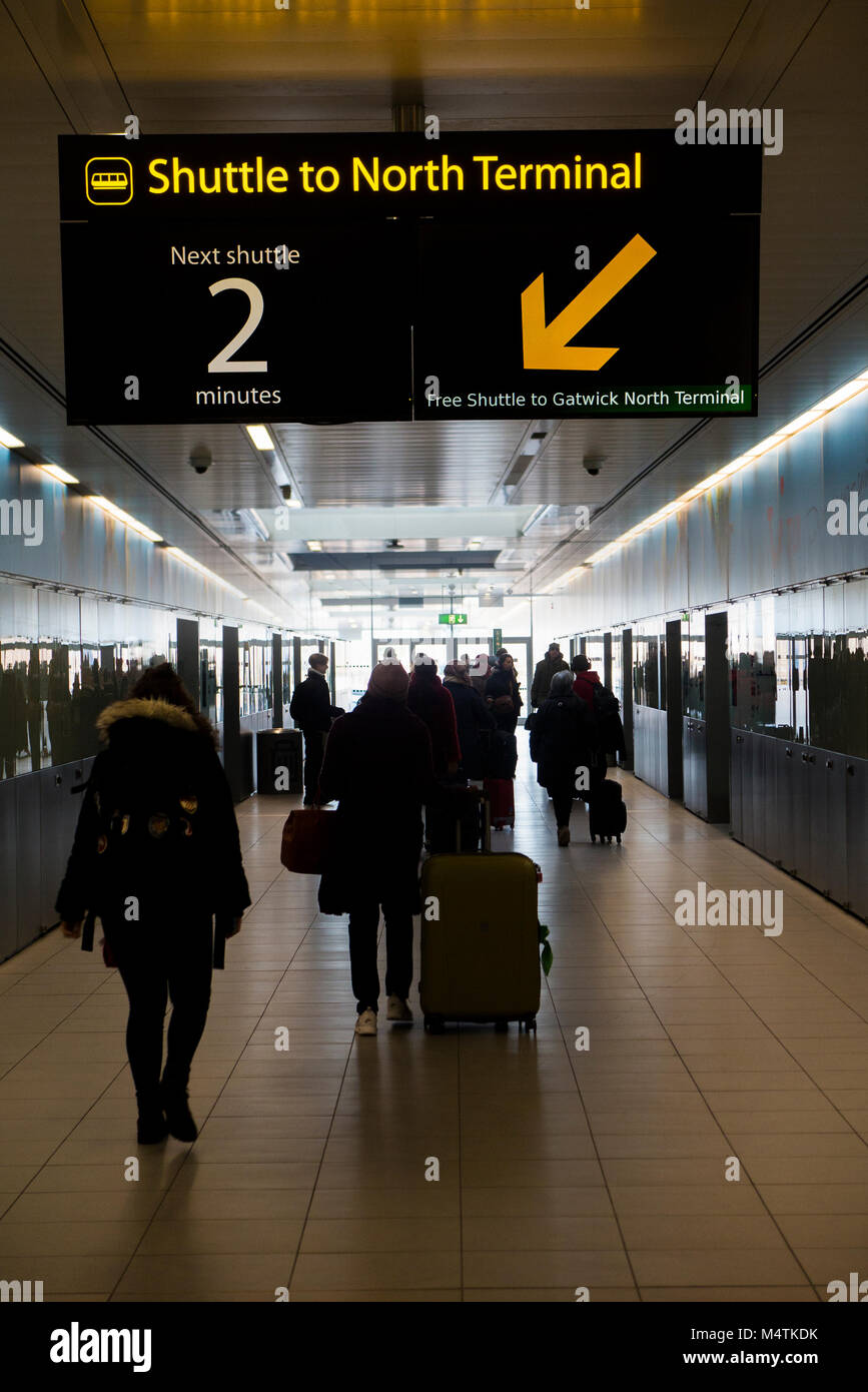 Travellers preparing to board the shuttle to the North Terminal at ...
