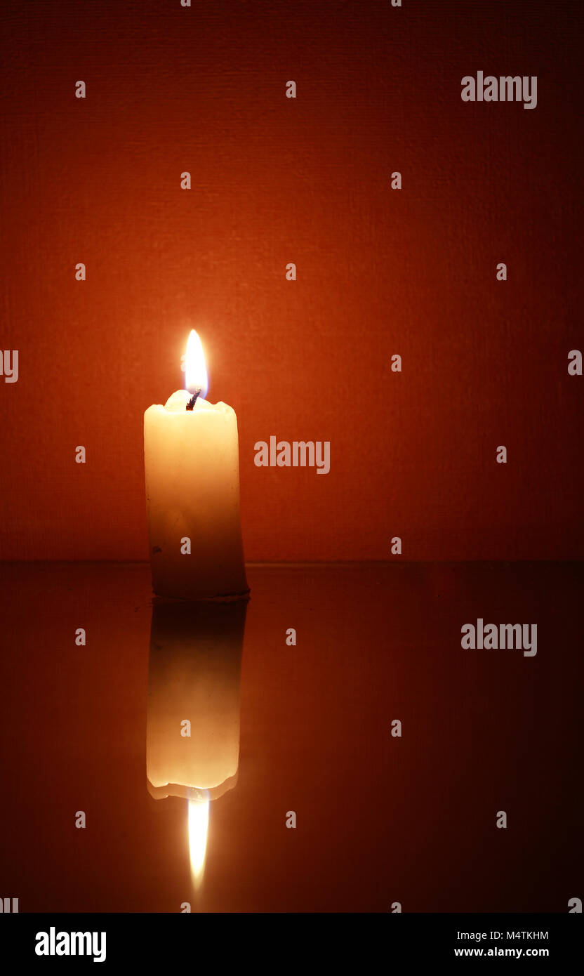 One lighting candle with reflection against dark background Stock Photo ...