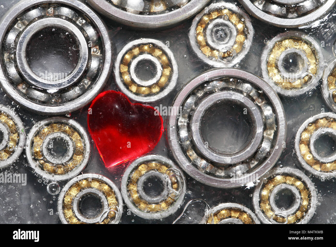Valentines Day greeting card. Red heart between ball bearings in frozen ...