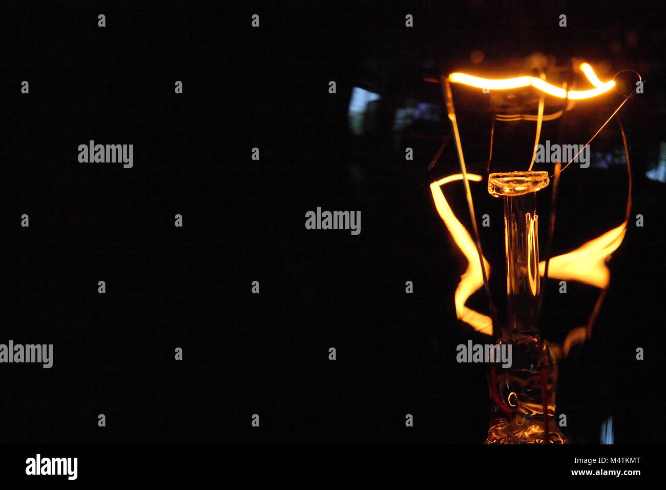 Closeup of glowing light bulb on black background with free space Stock ...