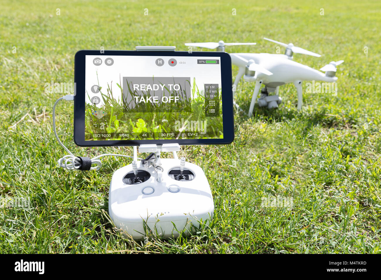 Digital tablet attached to drone controller showing ready to takeoff ...