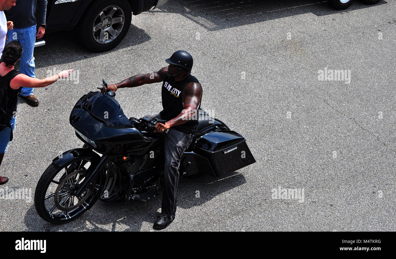 Man sitting stationary on his custom motorcycle with saddlebags Stock ...