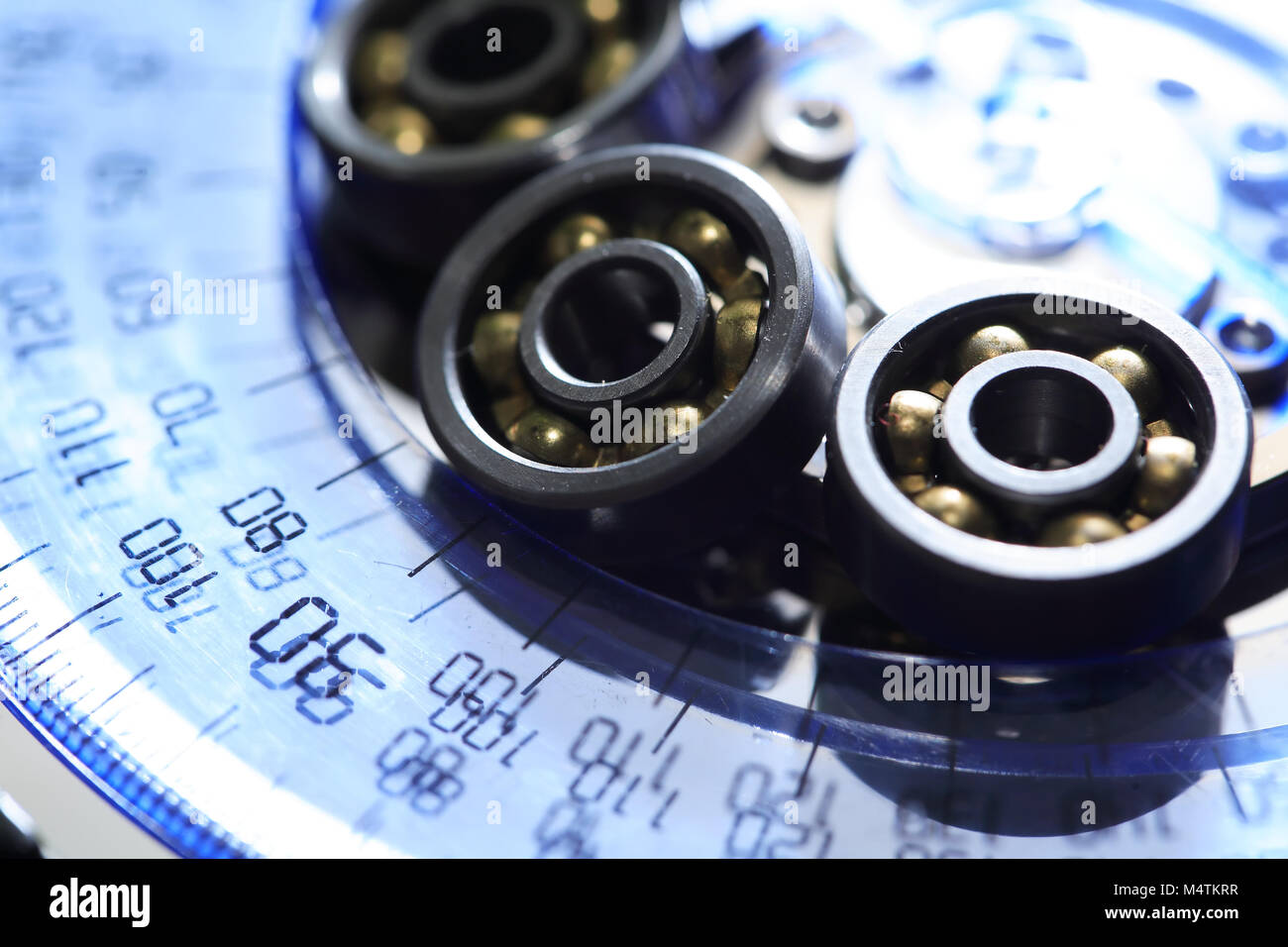 Engineering concept. Ball bearings set closeup on blue transparent ...