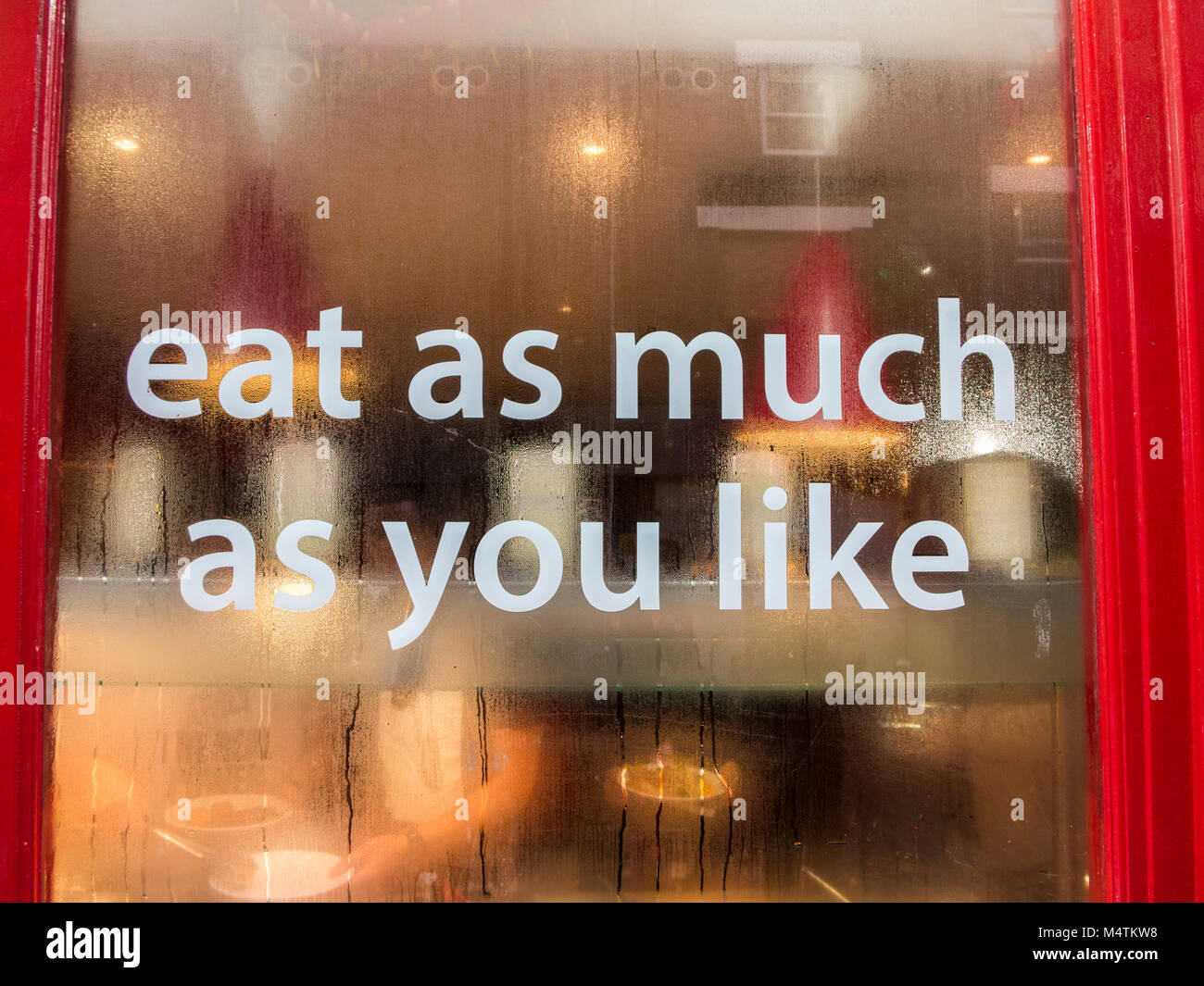 A sign in a restaurant window offering 'eat as much as you like' Stock ...