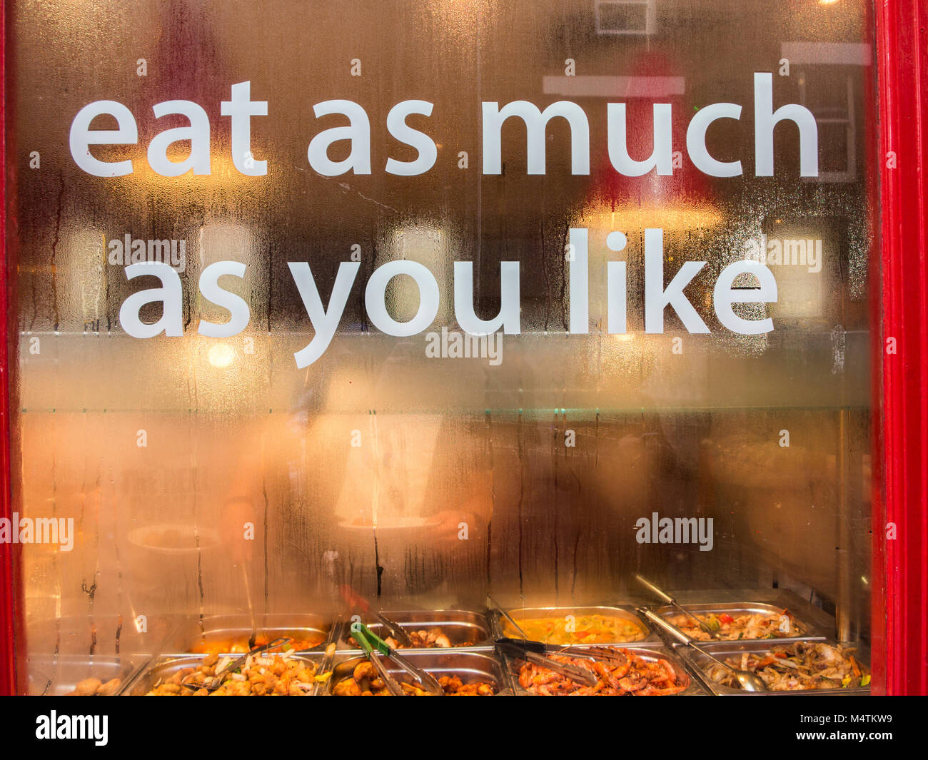 A sign in a restaurant window offering 'eat as much as you like' Stock ...