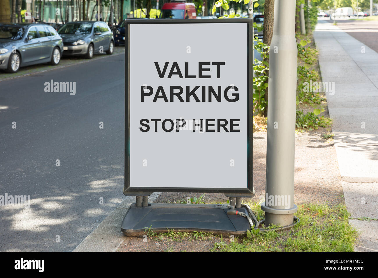 Valet parking sign on board by street in city Stock Photo - Alamy