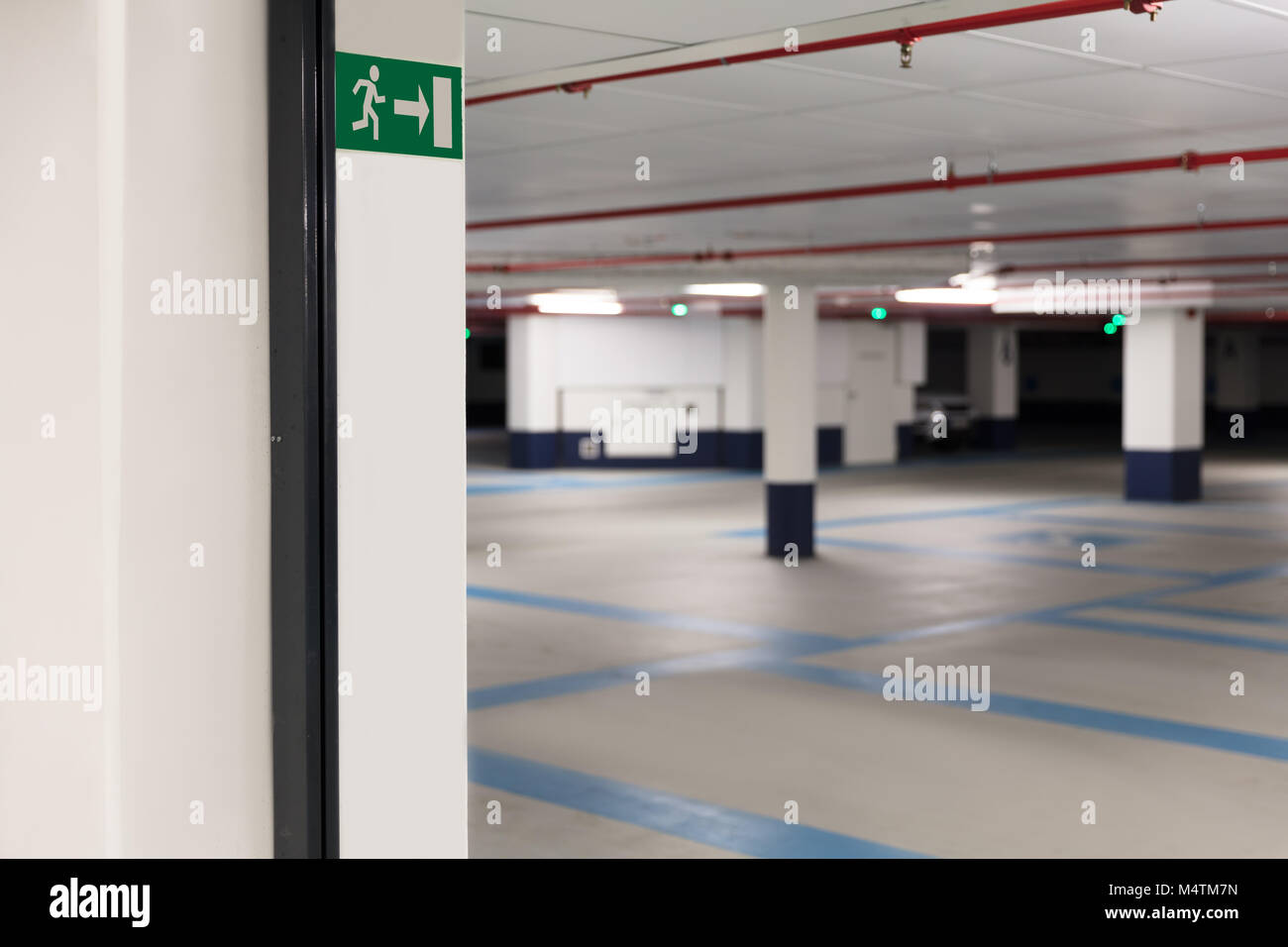 Emergency exit sign at entrance of underground parking lot Stock Photo ...