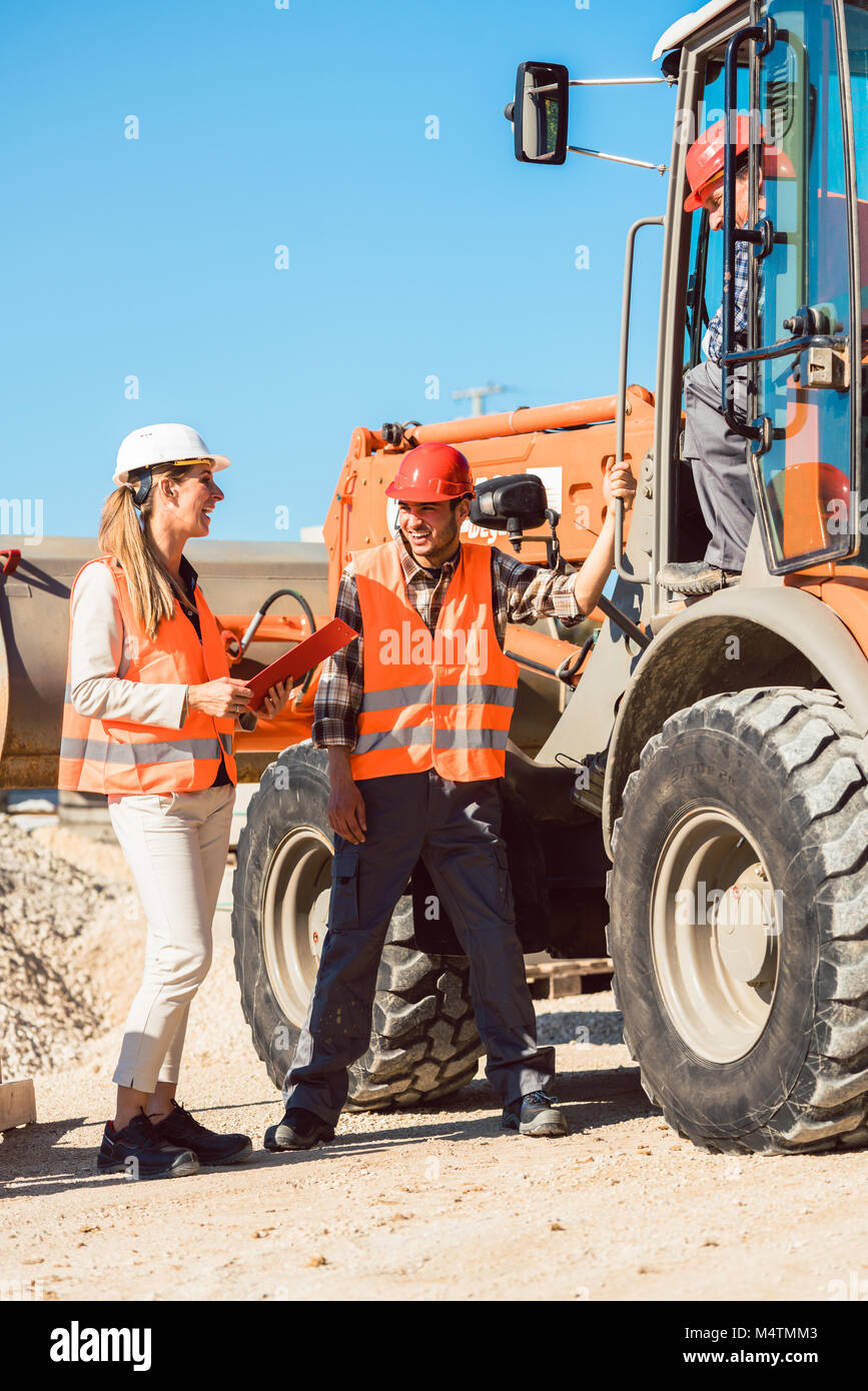 Civil engineer and worker discussion on road construction site Stock ...